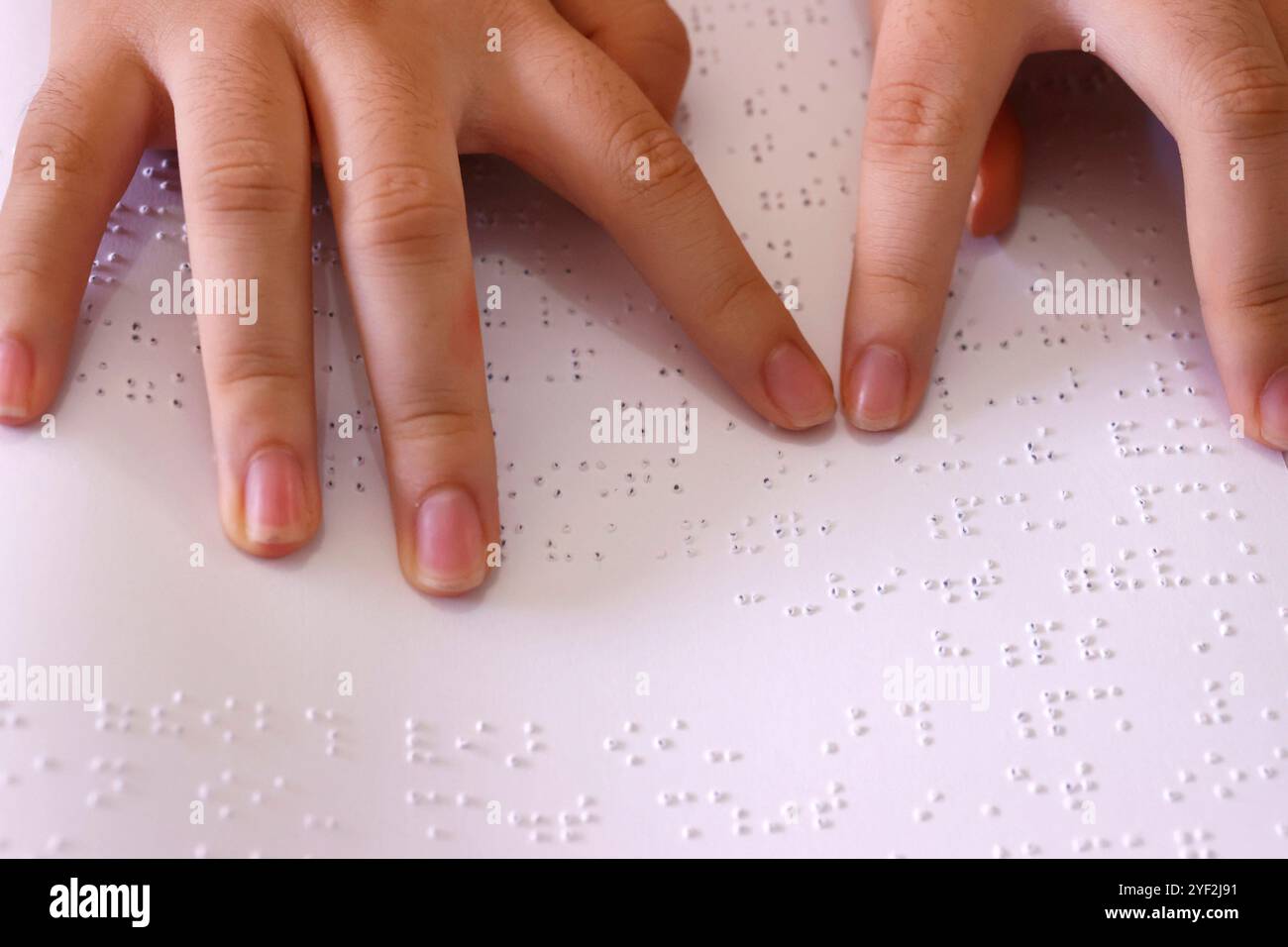 Center for blind children. Blind girl reading braille book Close up on ...