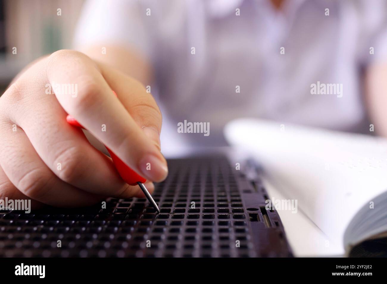 Center for blind children. Blind girl writing braille. Close up on ...