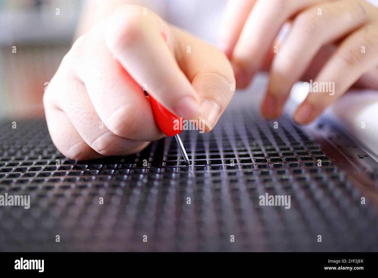 Center for blind children. Blind girl writing braille. Close up on ...