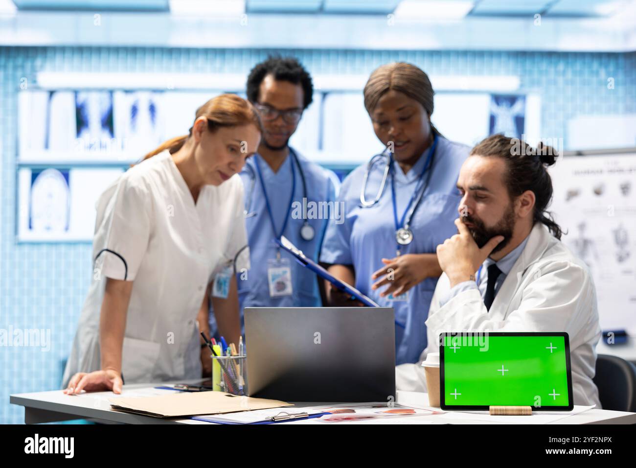 Licensed doctor and his staff review x ray scan results next to ...