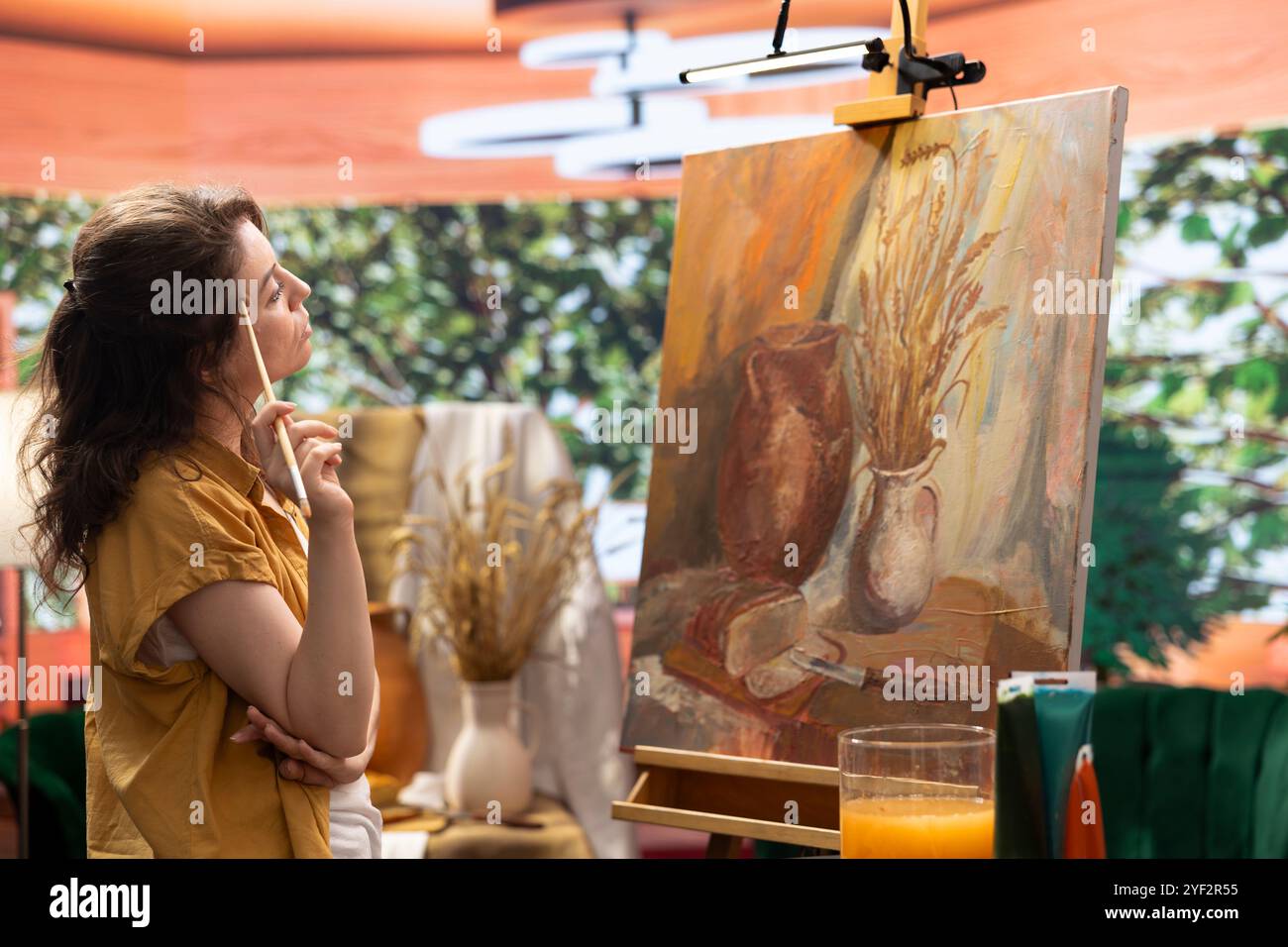 Inspired artist works on a canvas to create a masterpiece in atelier ...