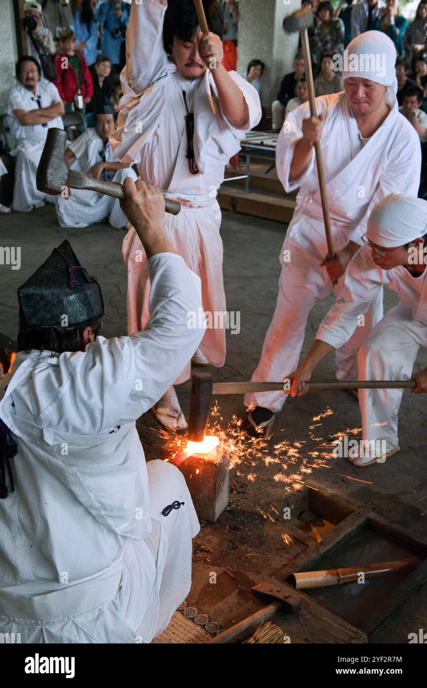 Traditional Japanese sword makers hammering red hot iron in the ...