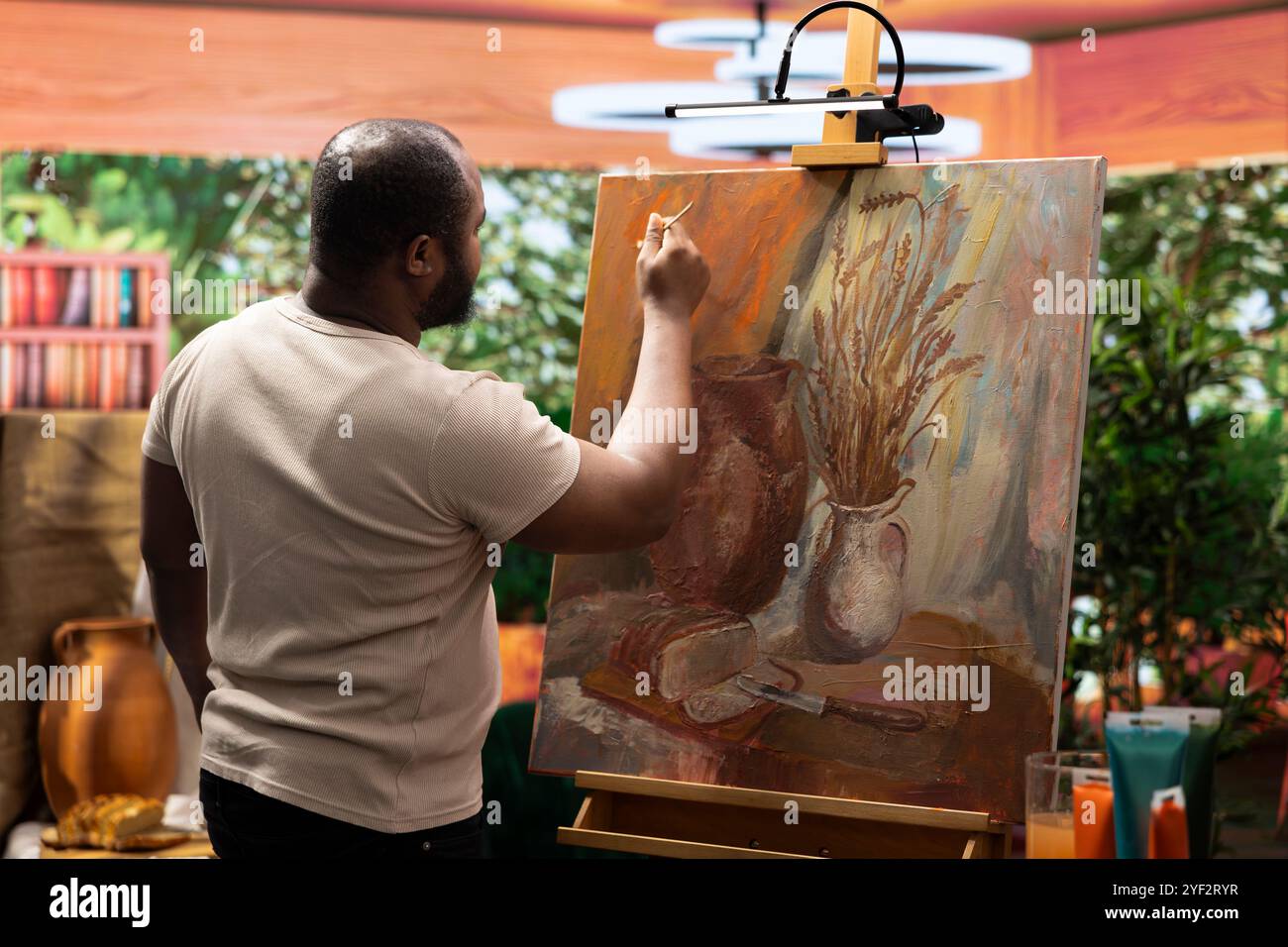 African american artist using his skill to paint a new creation in art ...