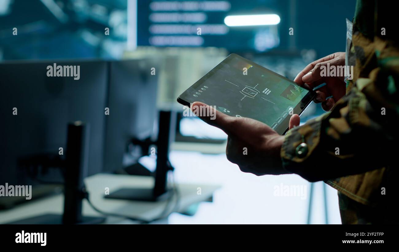 Military officer leads cybersecurity operations in a high tech ...