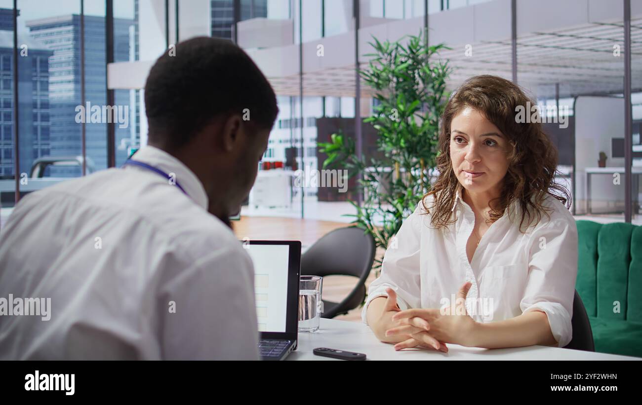 Recruiter interviewing job applicant to learn about her qualifications ...