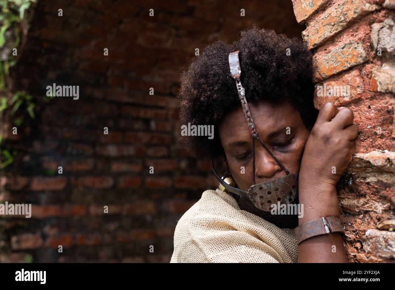 Black woman chained and with an iron mask over her mouth and her face ...