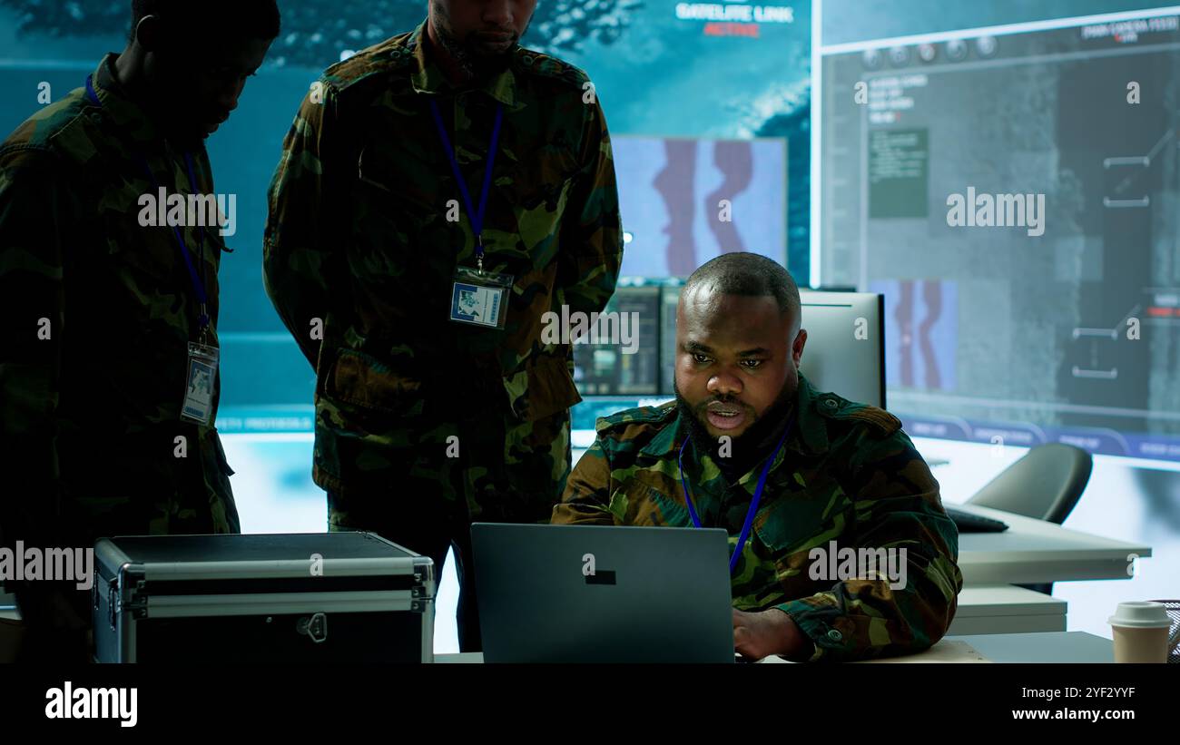 Military personnel in a modern command center handle critical ...