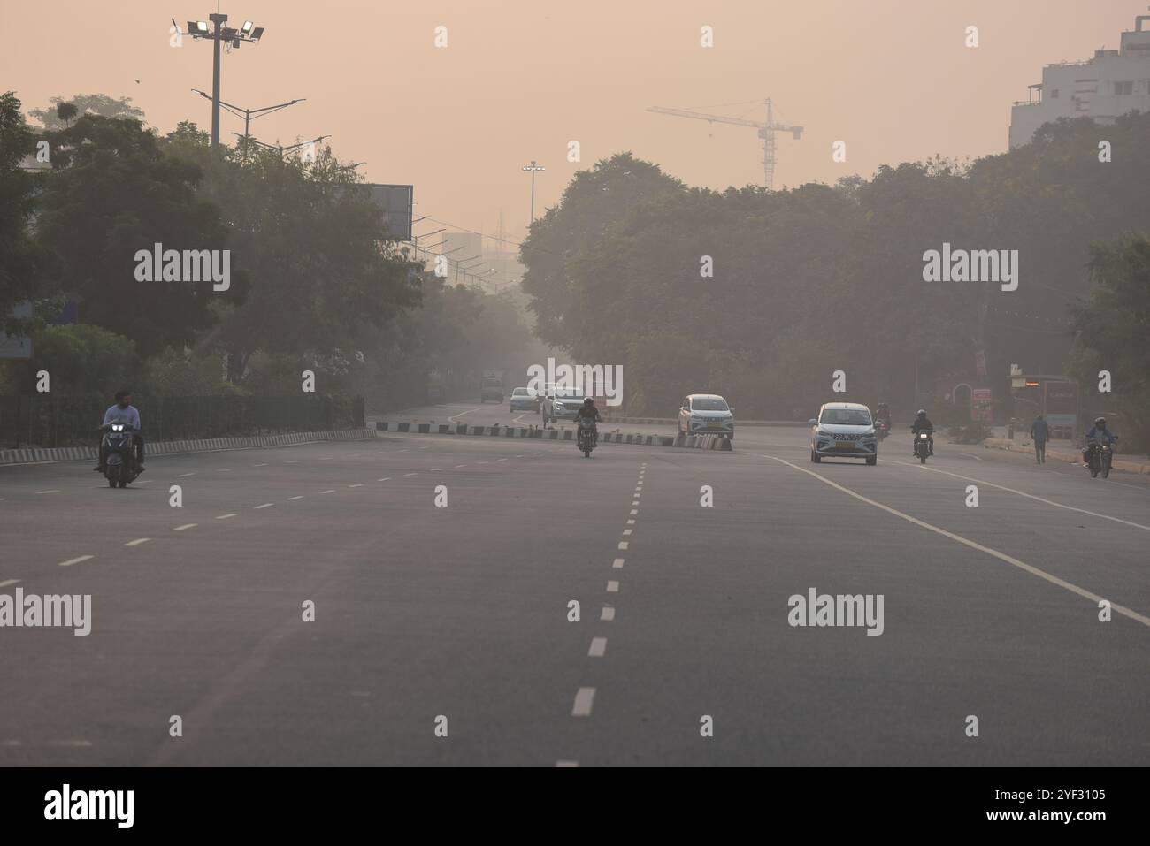 GURUGRAM, INDIA - NOVEMBER 2: People going to work and a thick layer of ...