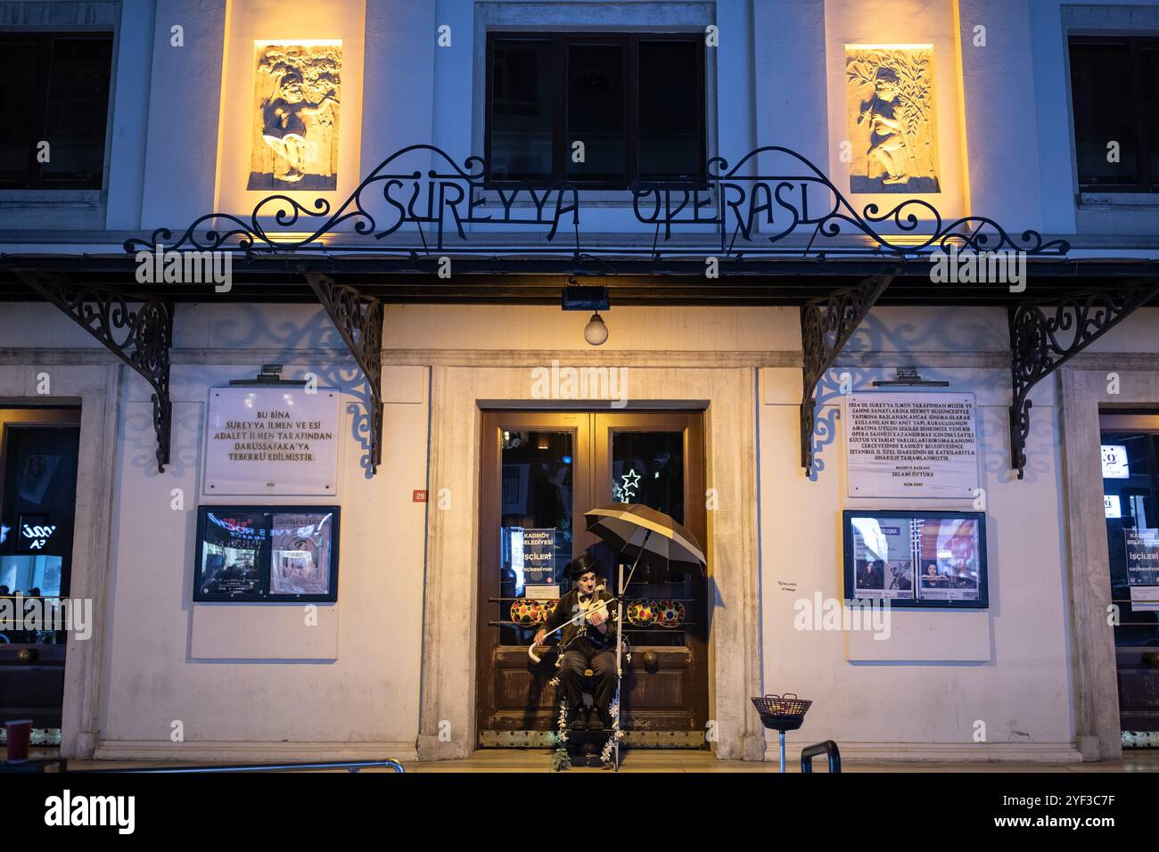Mustafa Guneyli, dressed as Charlie Chaplin, performs in front of the ...