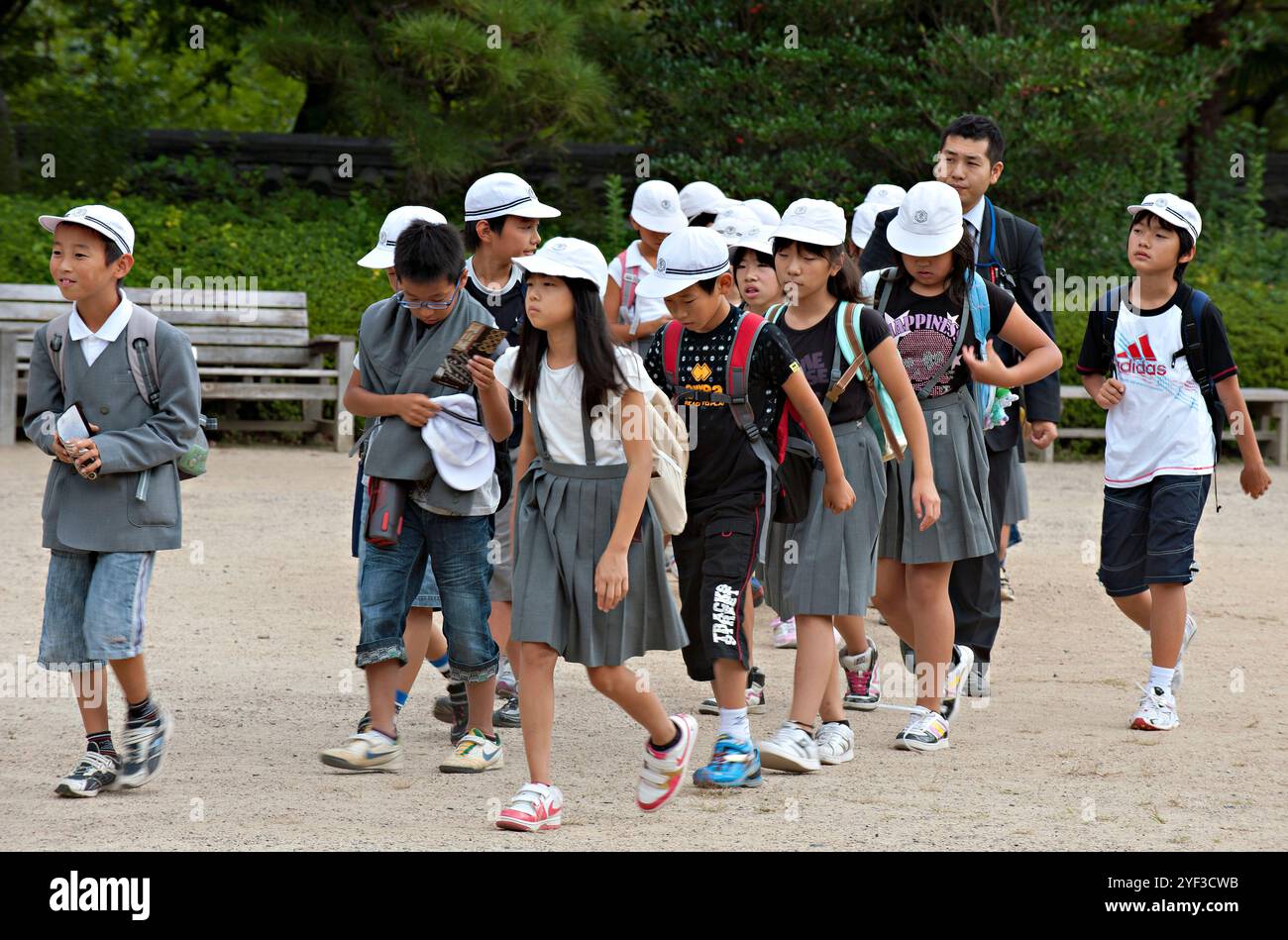 Group of elementary school kids wearing matching uniforms on an outing ...
