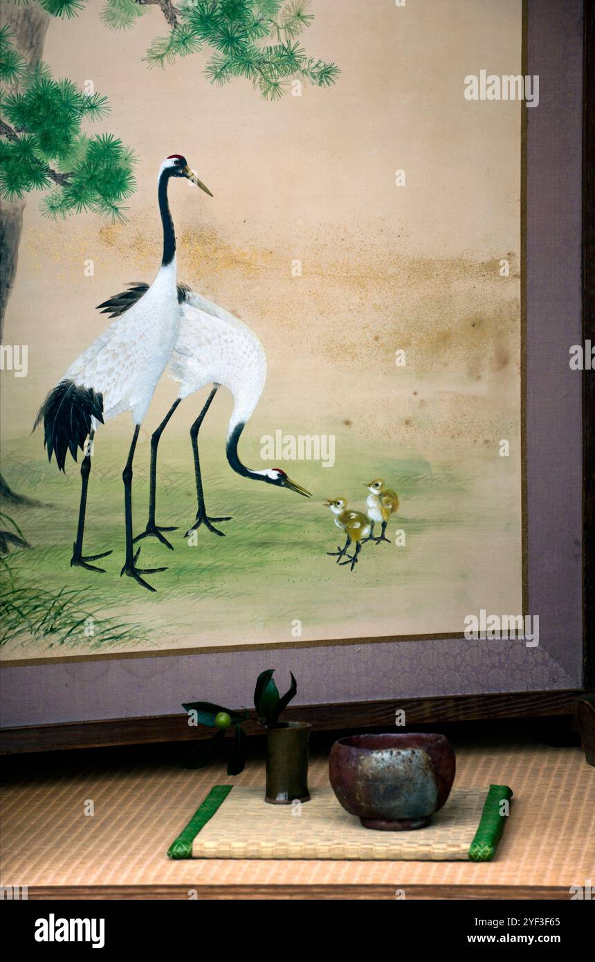 An historic art panel depicting two "tsuru" (cranes) and their chicks ...