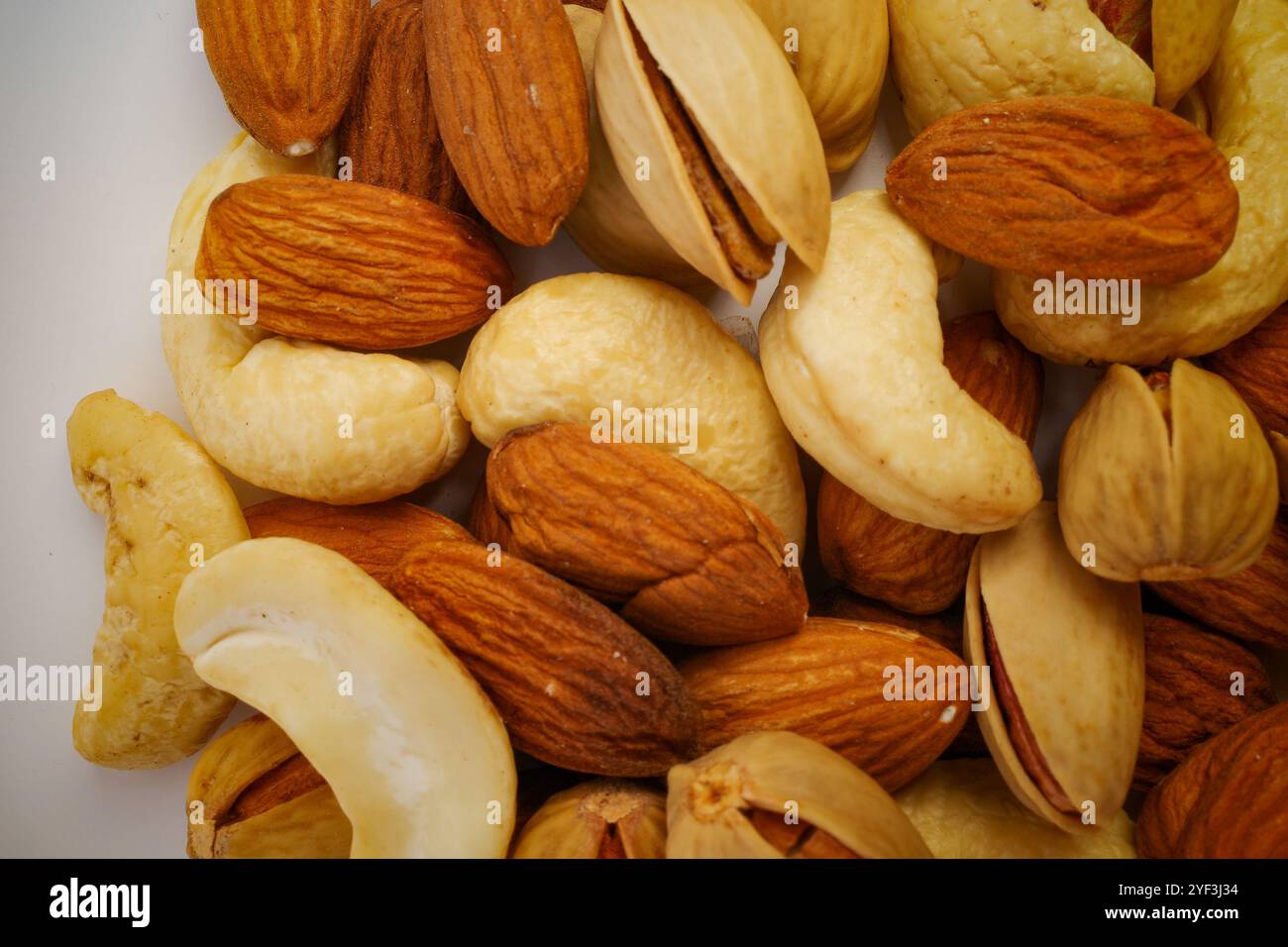 Mixed nuts inside an open snack bag with almonds and cashews Stock ...