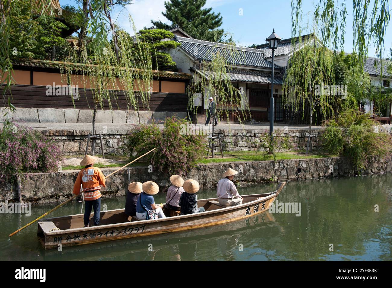 Group of tourists in a canal boat gliding along the Kurashiki River in ...