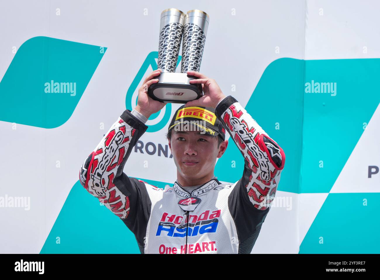 Japanese rider Taiyo Furusato of Honda Team Asia holds up his trophy ...