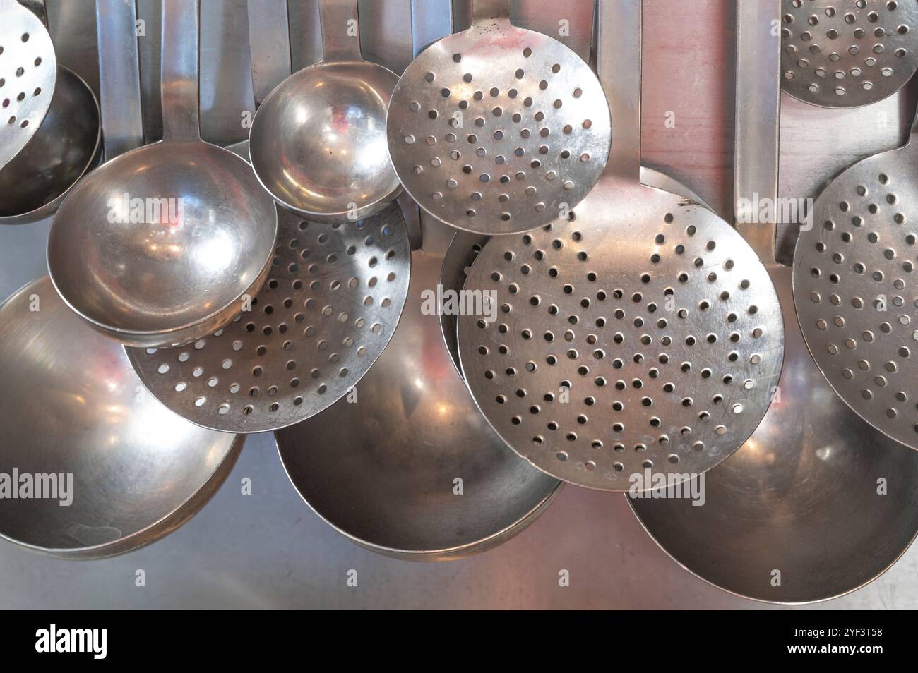 Kitchen ladles made from metal hanging in the ship's galley of MS ...