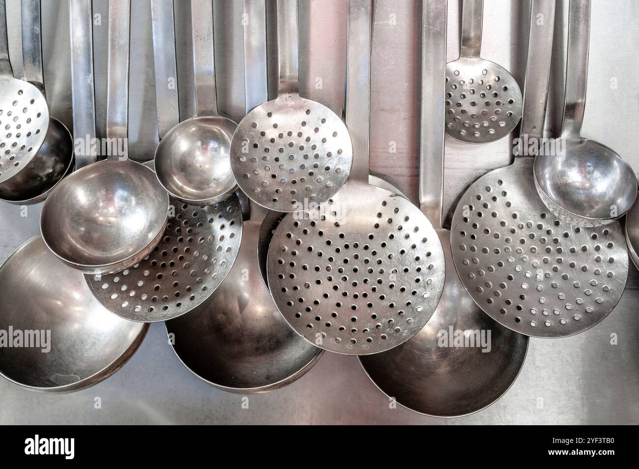 Kitchen ladles made from metal hanging in the ship's galley of MS ...