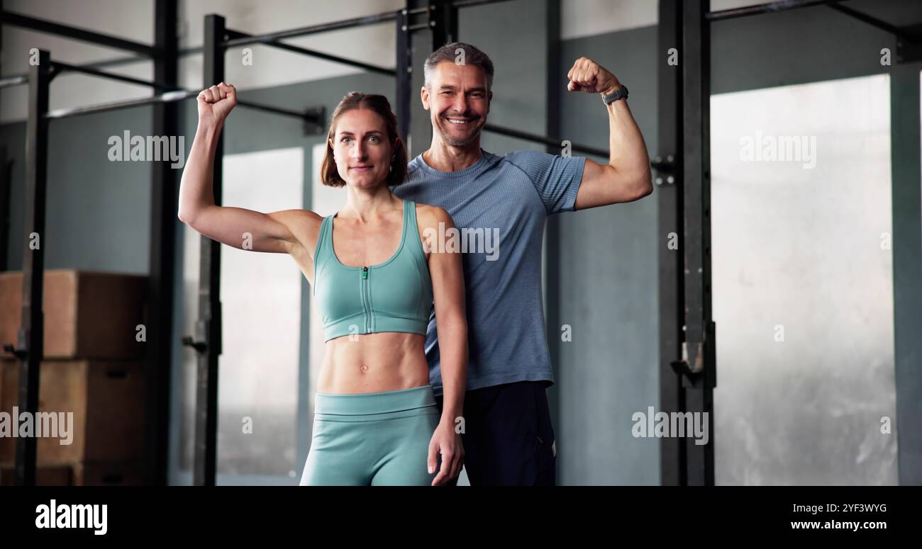 Strong Couple In Gym Showing Biceps. Friendship And Fun. Fitness ...