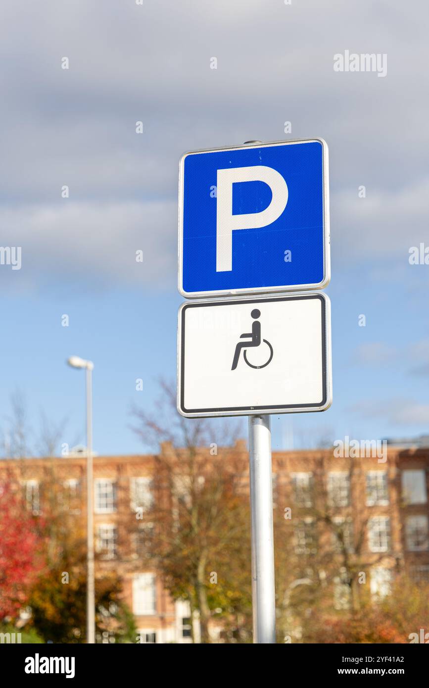 A blue parking sign indicating designated parking for people with ...