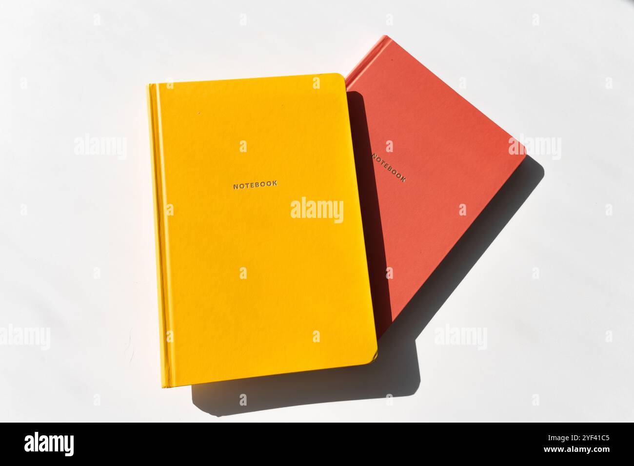 Yellow and Red Notebooks on Stock Photo - Alamy