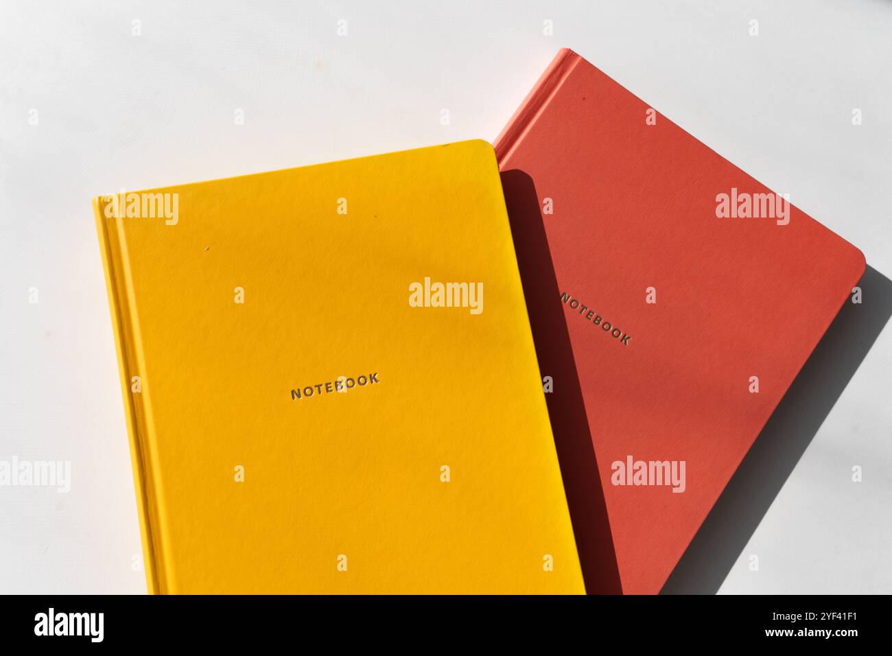 Yellow and Red Notebooks on Stock Photo - Alamy