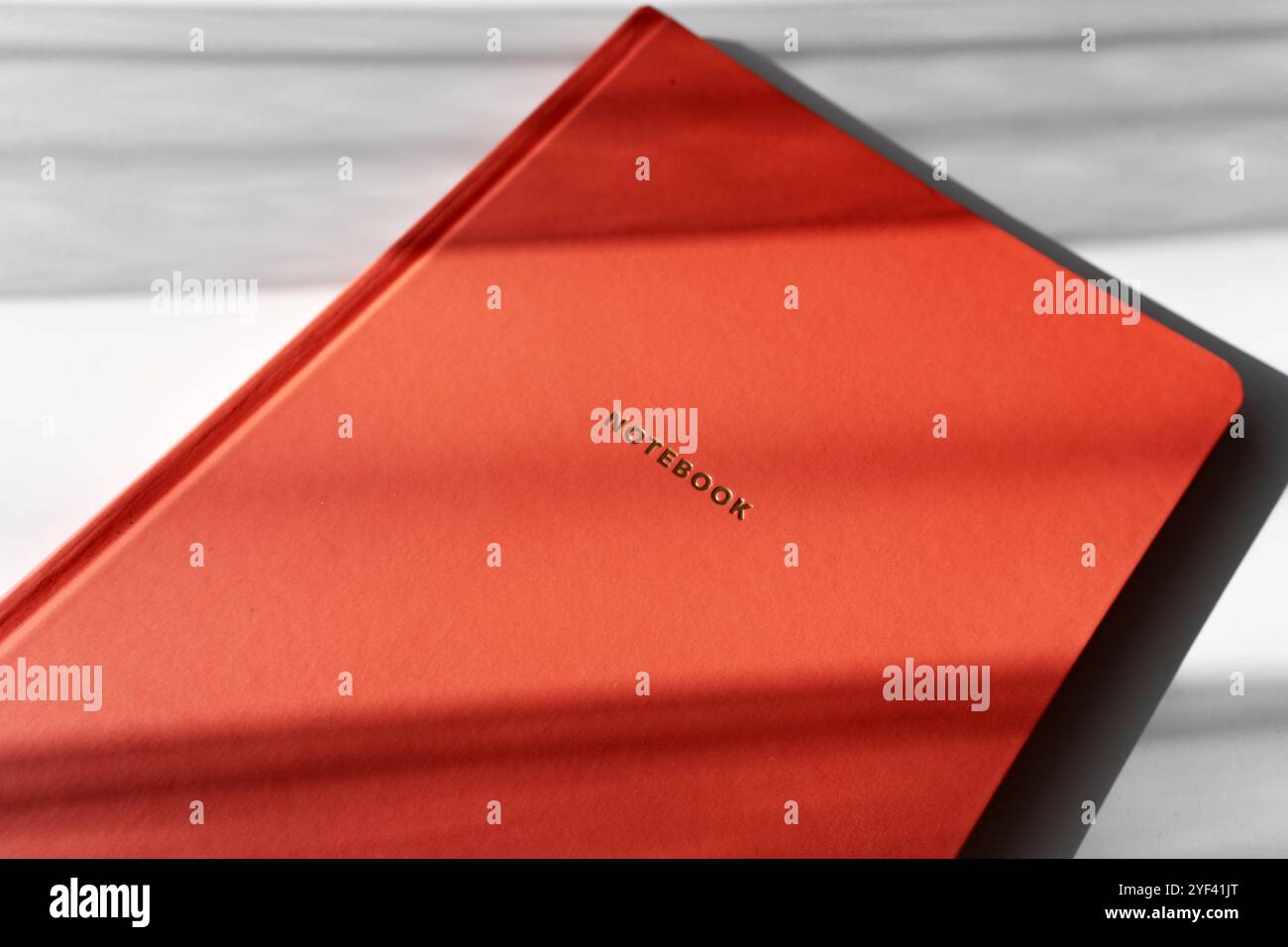 Minimalist Red Notebook with Shadows Stock Photo - Alamy