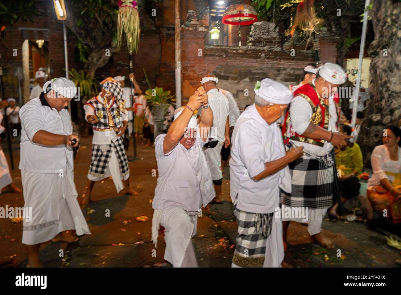 Balinese men stab themselves with kiris at Ngurek or Ngunying ritual ...