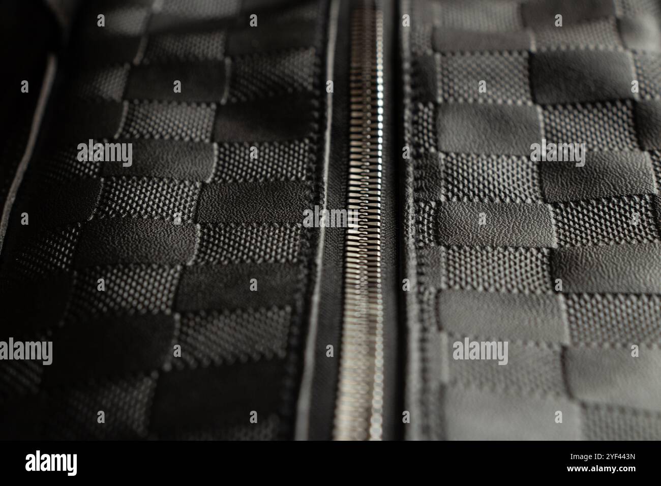 Black checkered faux leather with a zipper in the middle as a ...