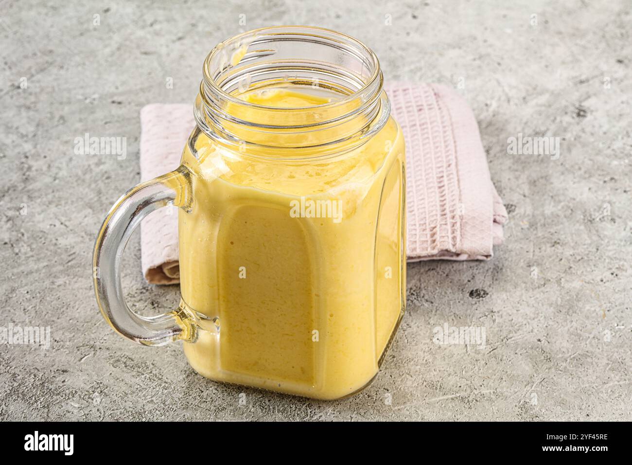 Cold sweet mango smoothie glass with ice Stock Photo - Alamy