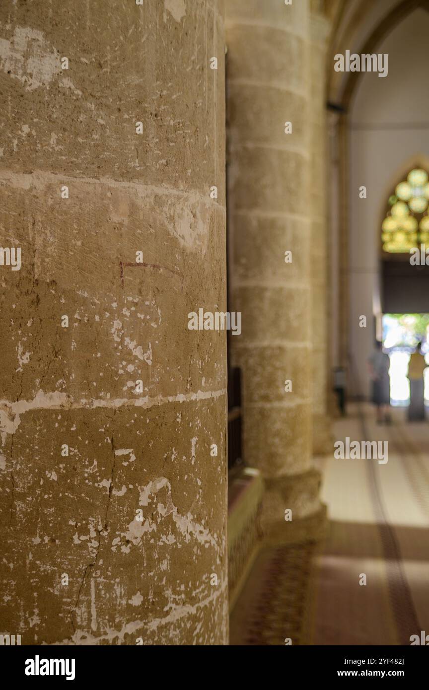 Sunlight streams through stained glass, illuminating weathered stone ...