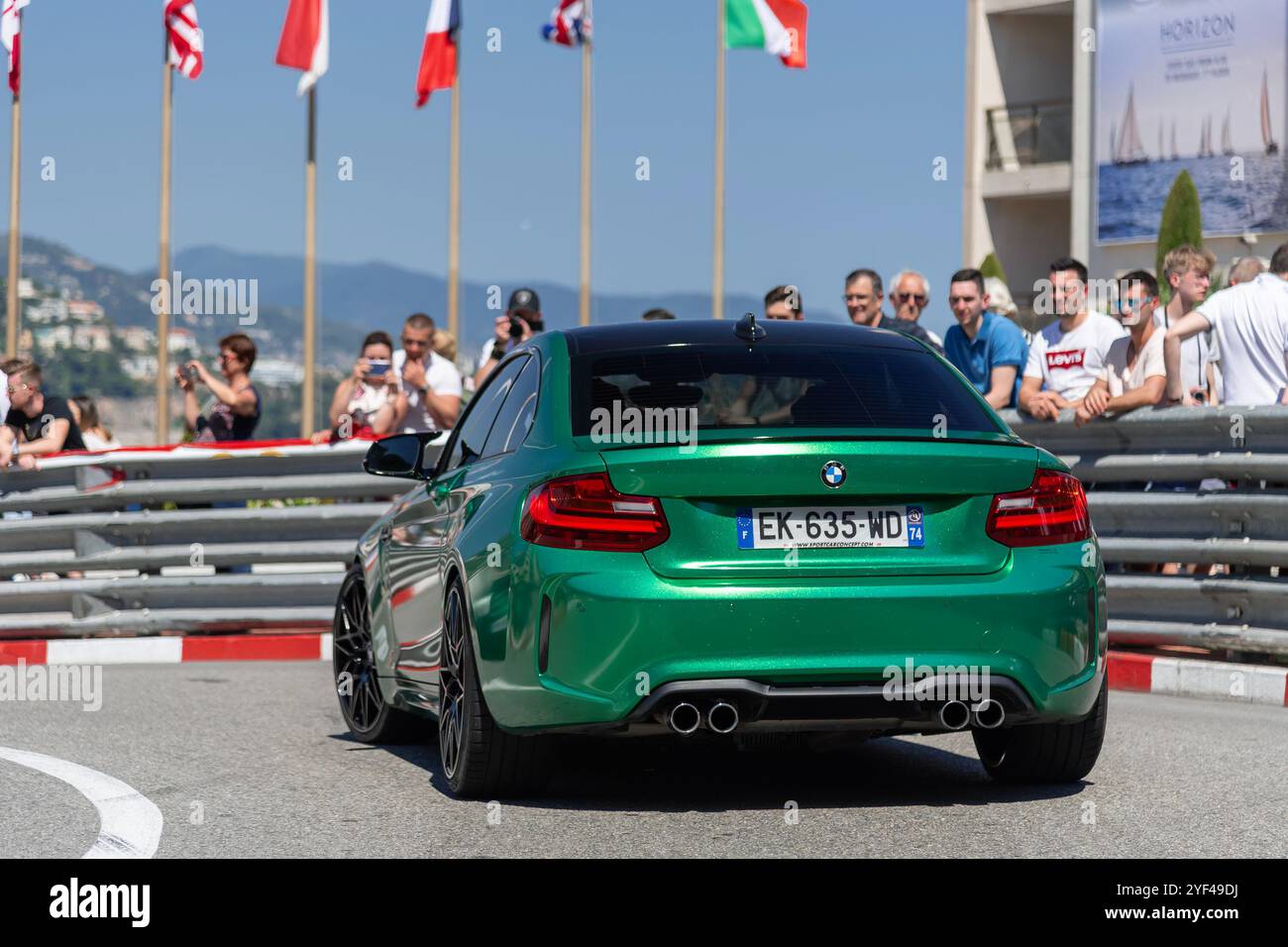 Monte Carlo, Monaco - View on a green BMW M2 driving on the road in the ...