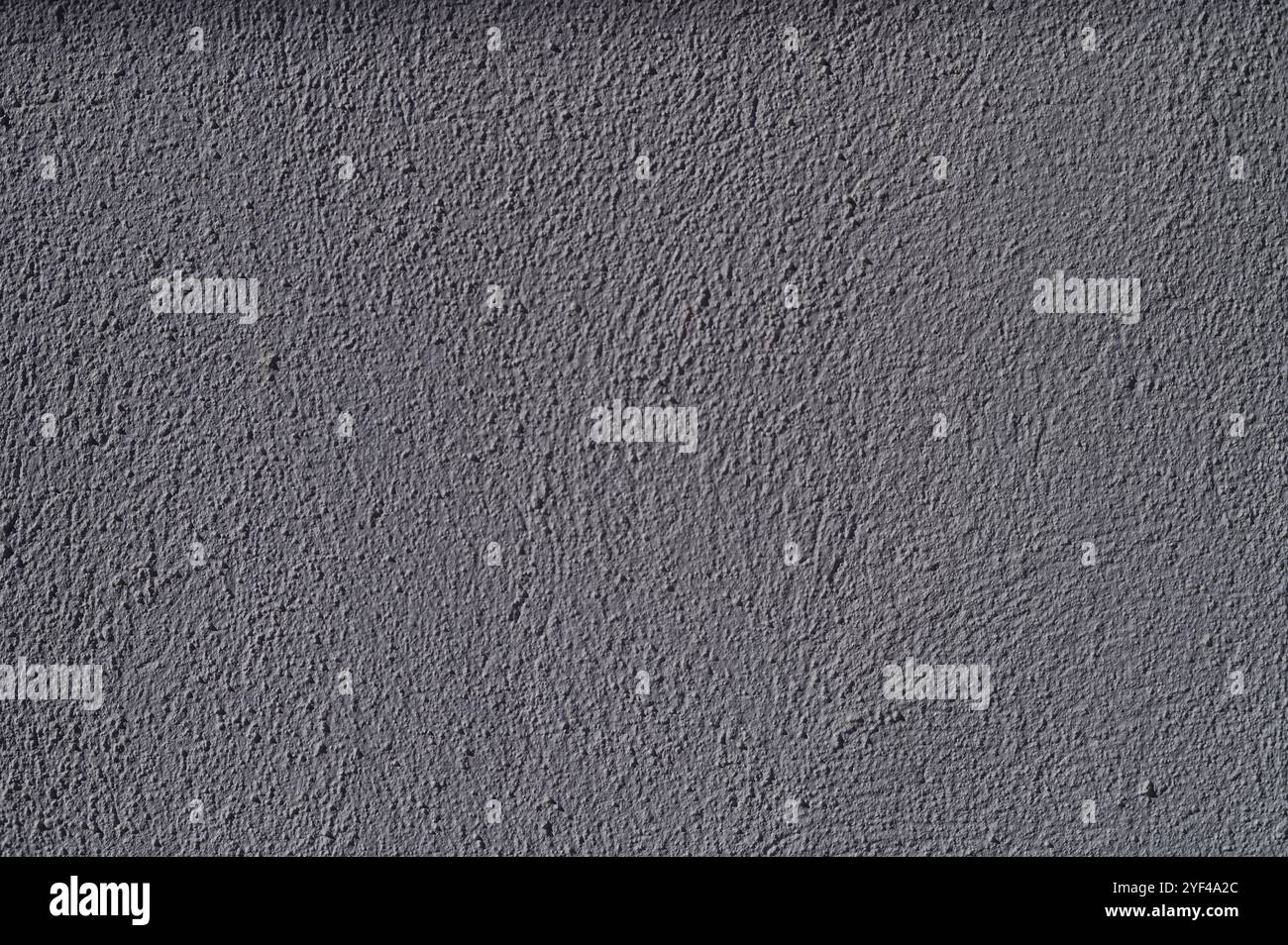 A close-up view reveals a textured gray wall highlighting intricate ...