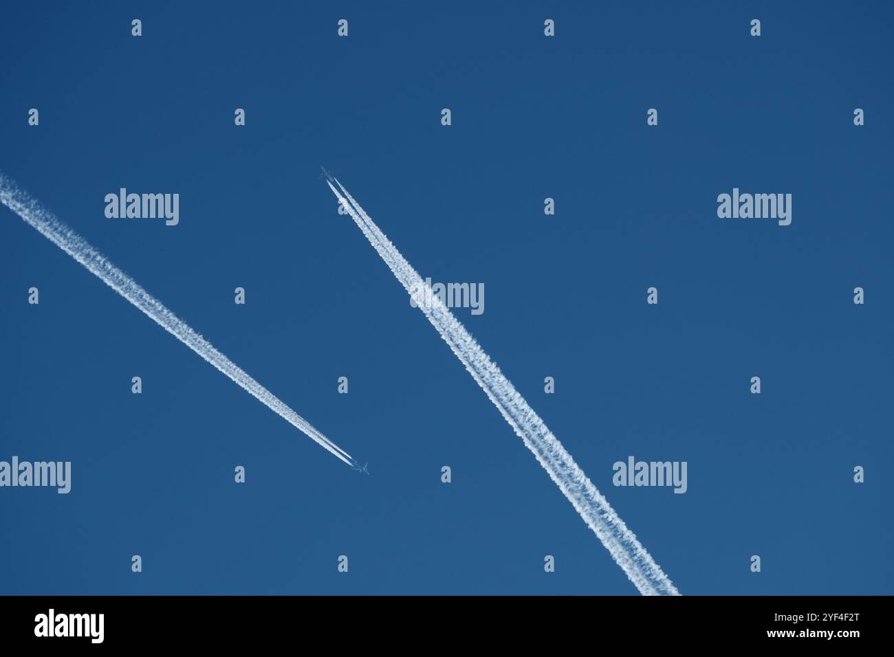 Airplane trails in the blue sky, contrails Stock Photo - Alamy
