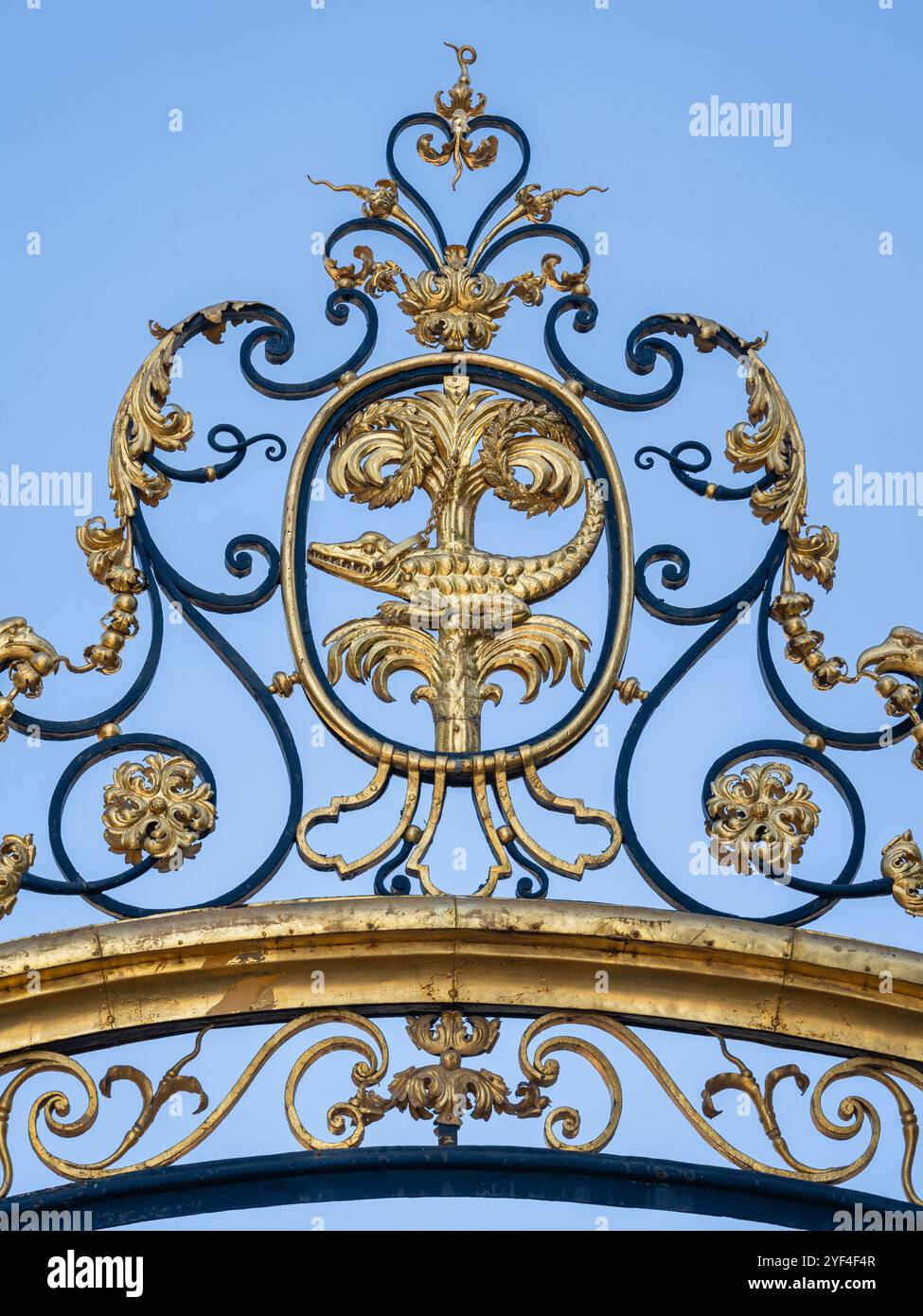 View of old golden cast iron decor with crocodile and palm tree - coat ...