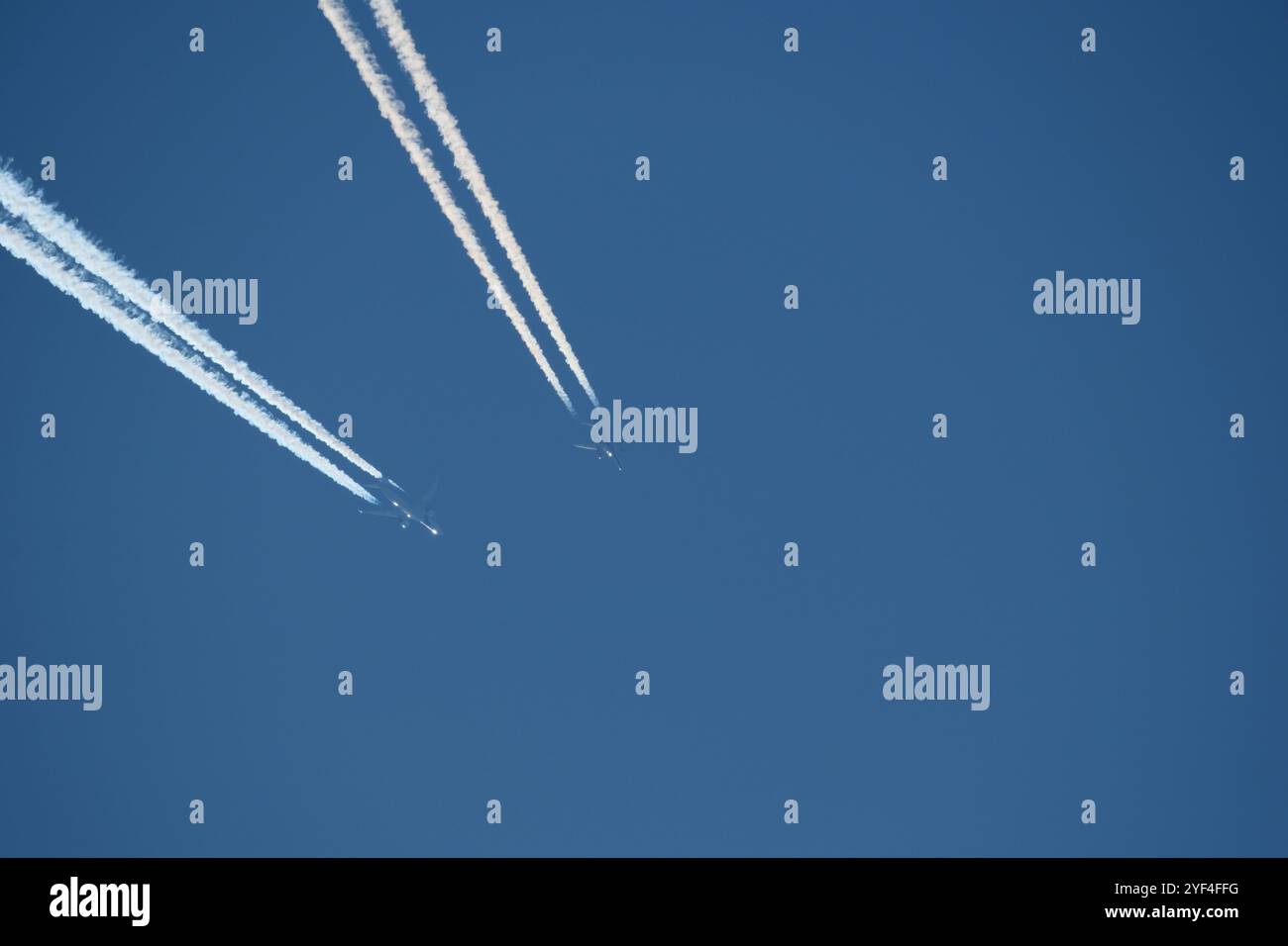 Airplane trails in the blue sky, contrails Stock Photo - Alamy