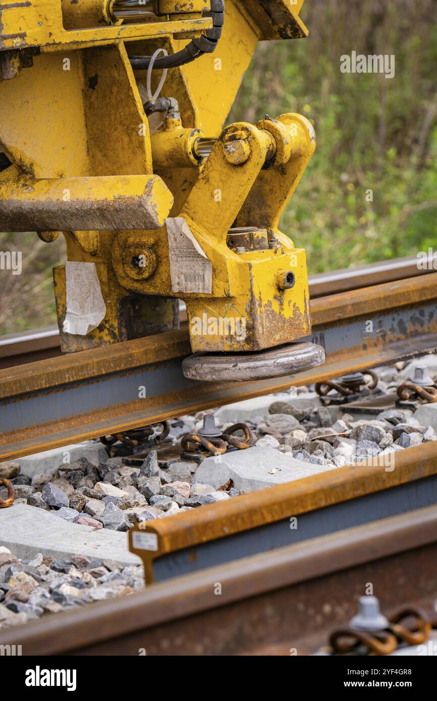 Yellow construction machine working on a railway track, track ...