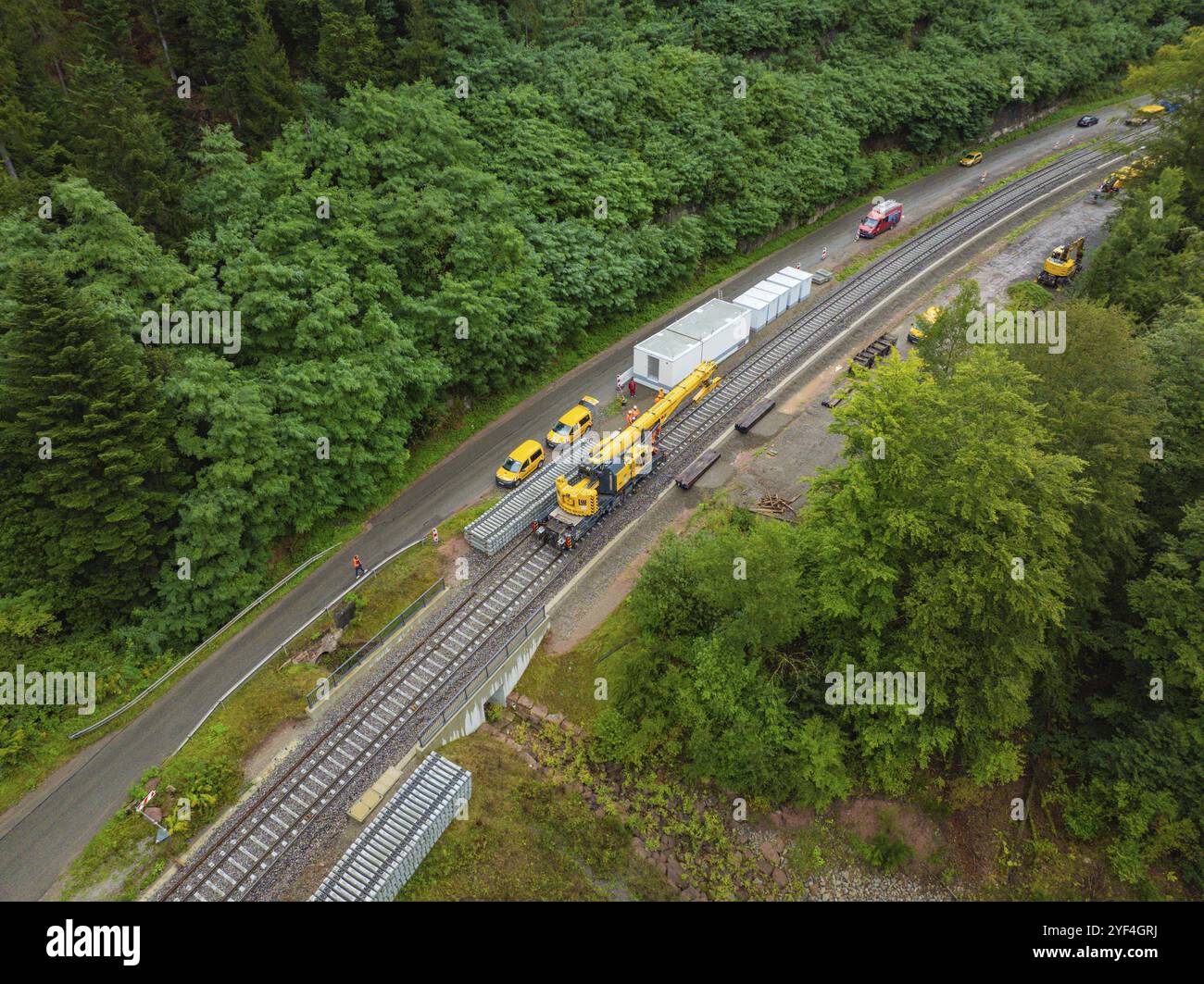 Aerial view of a railway line with longer track, vehicles and ...