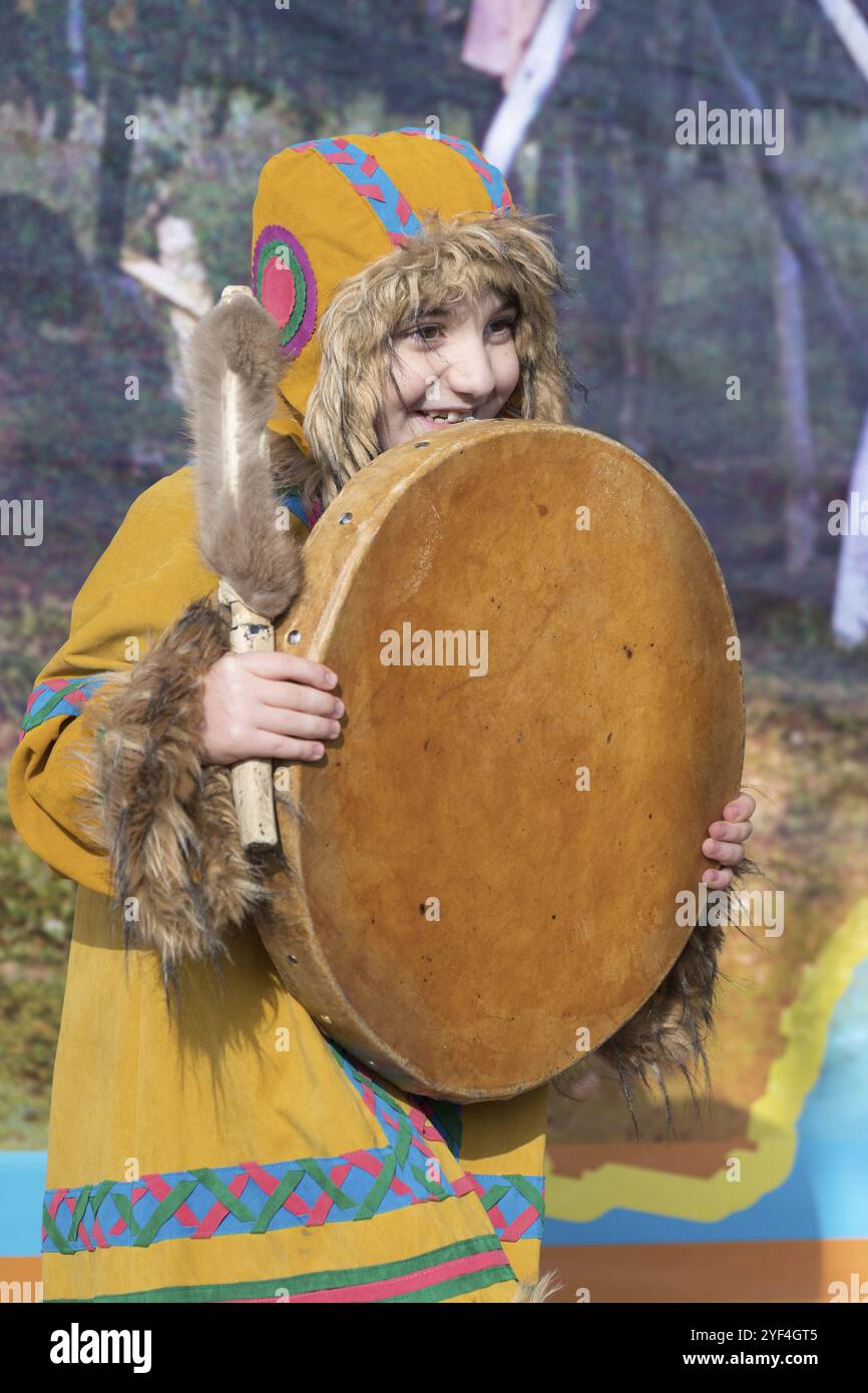 Female child dancing with tambourine in national clothing indigenous ...
