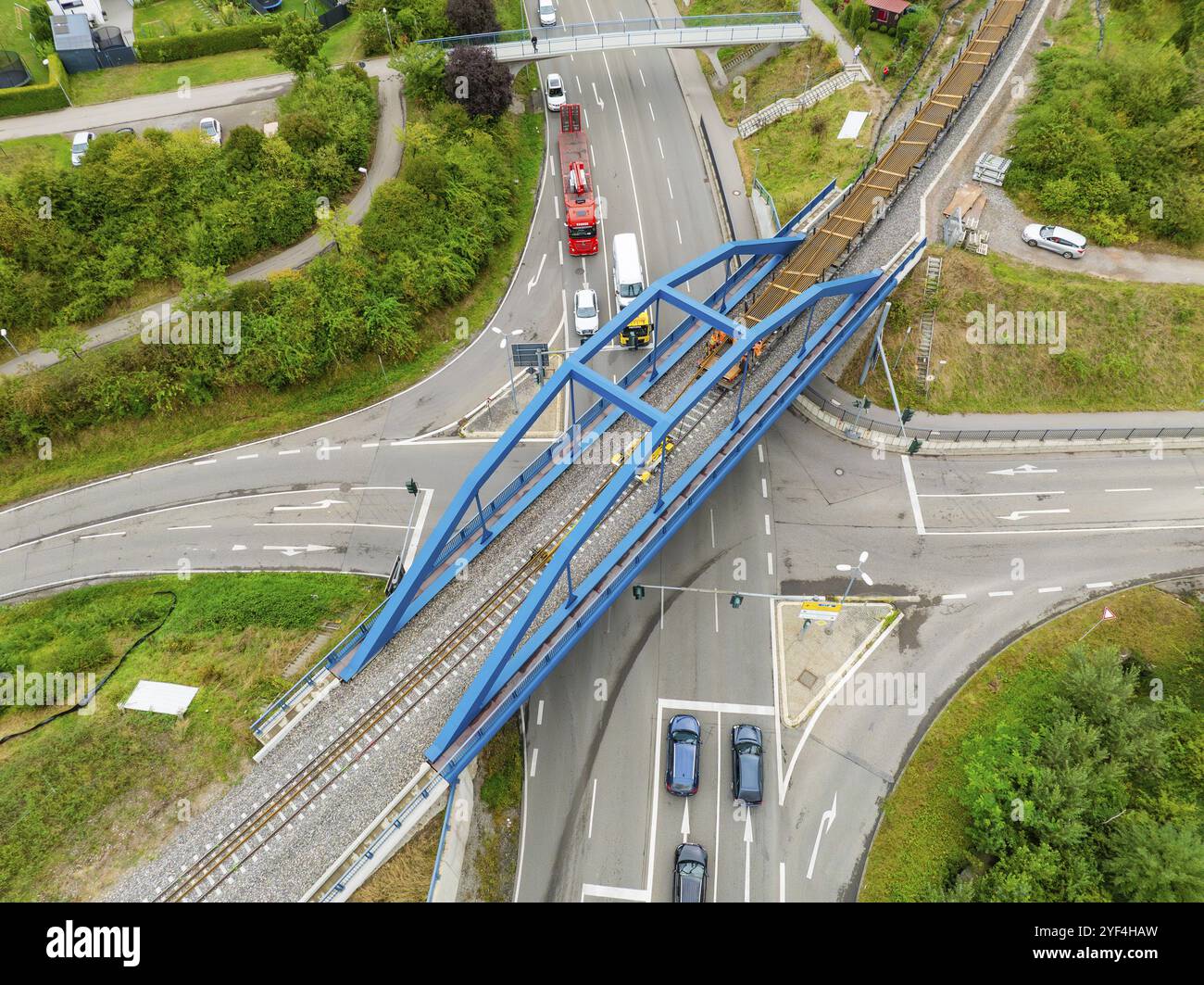 Aerial view of road and rail crossing with blue bridge scaffolding ...
