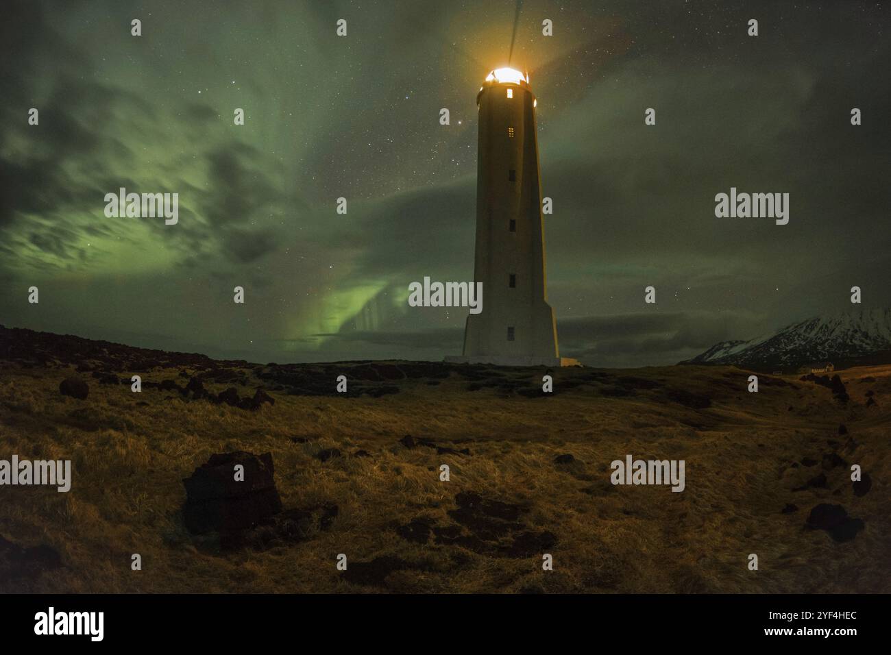 Northern lights or aurora borealis, lighthouse sends light signal ...