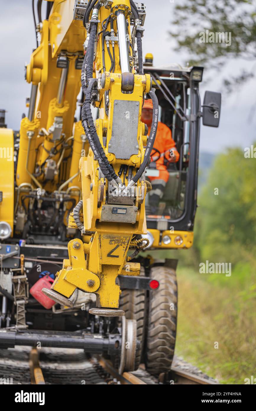 Heavy construction machine with hydraulic arm carries out track work ...