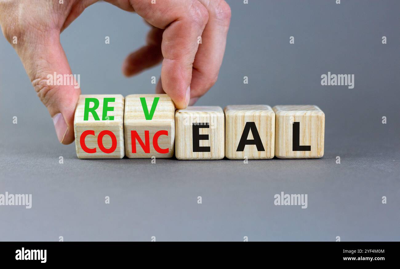 Reveal or conceal symbol. Businessman turns wooden cubes and changes ...