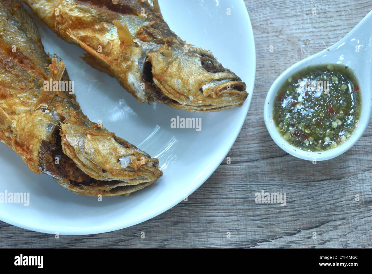 deep fried croaker fish dipping Thai spicy seafood sauce on plate Stock ...
