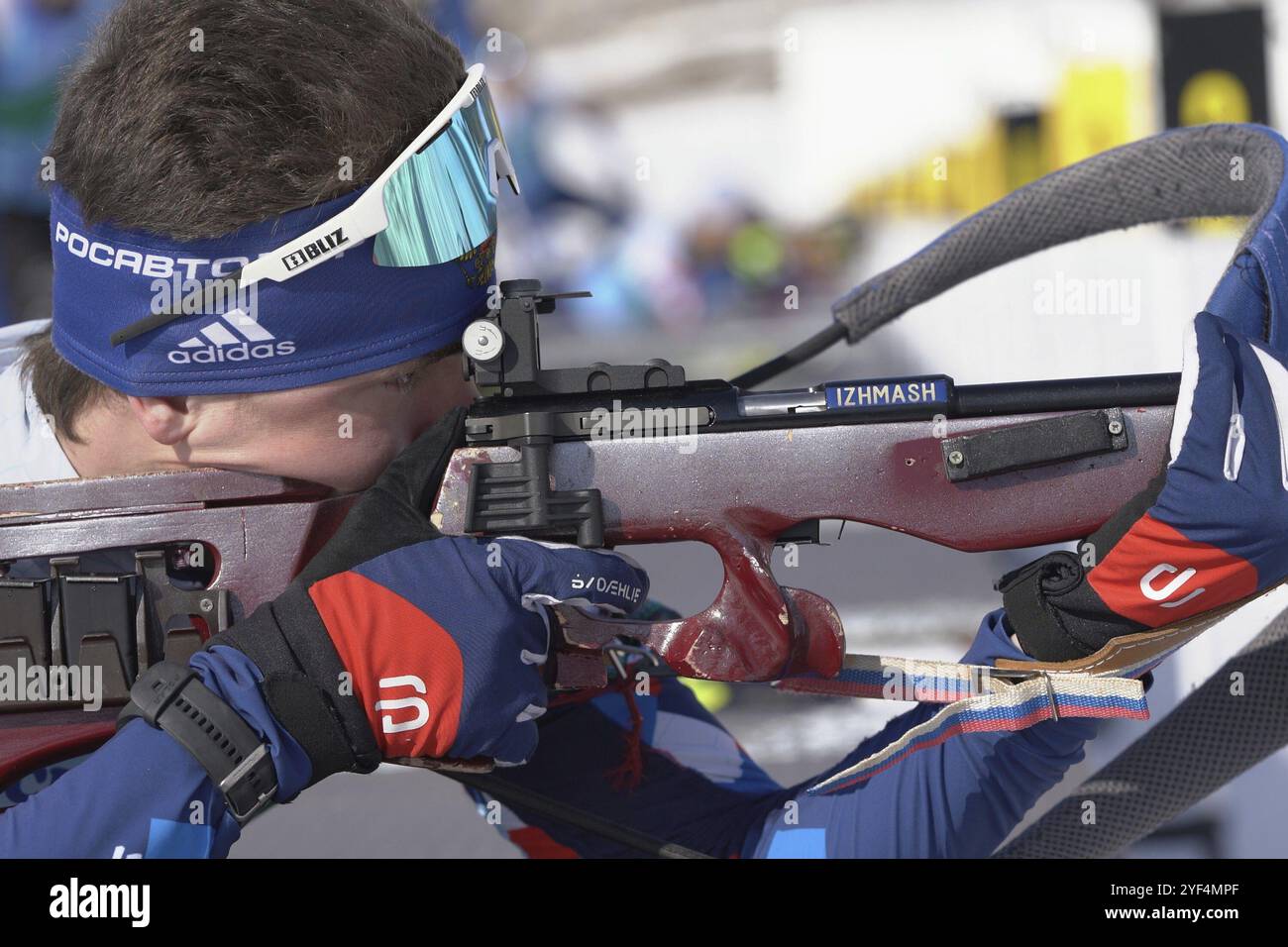 Sportsman biathlete rifle shooting, aiming, reloading rifle in prone ...