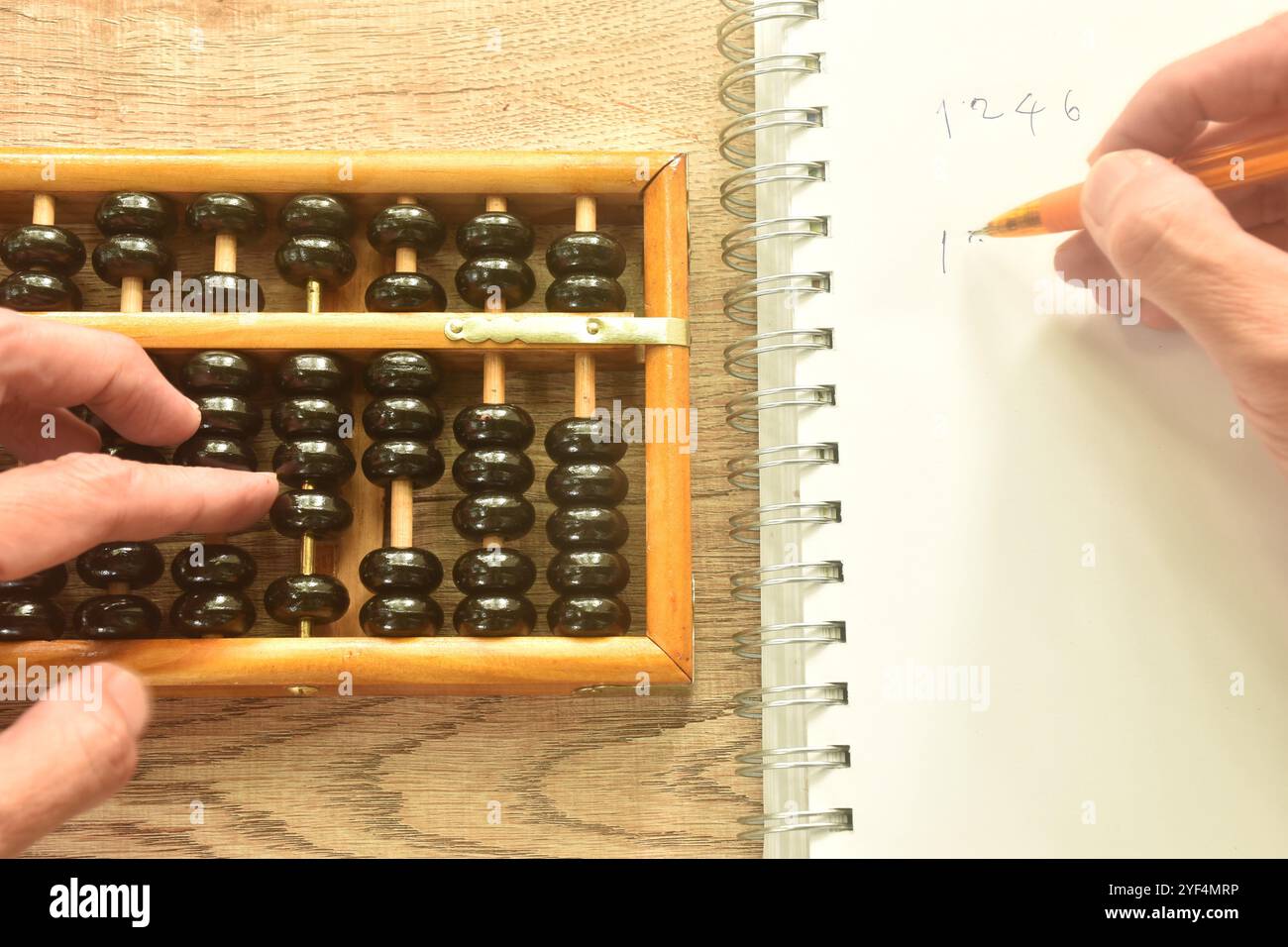 hand used wooden abacus old Chinese tool for calcuated and note in book ...