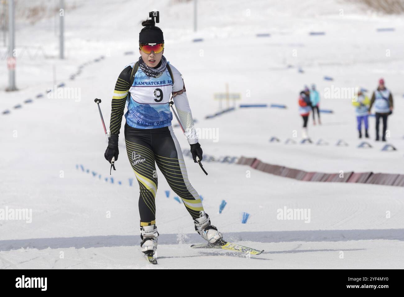 Korean sportswoman biathlete skiing at finish after rifle shooting. Lee ...
