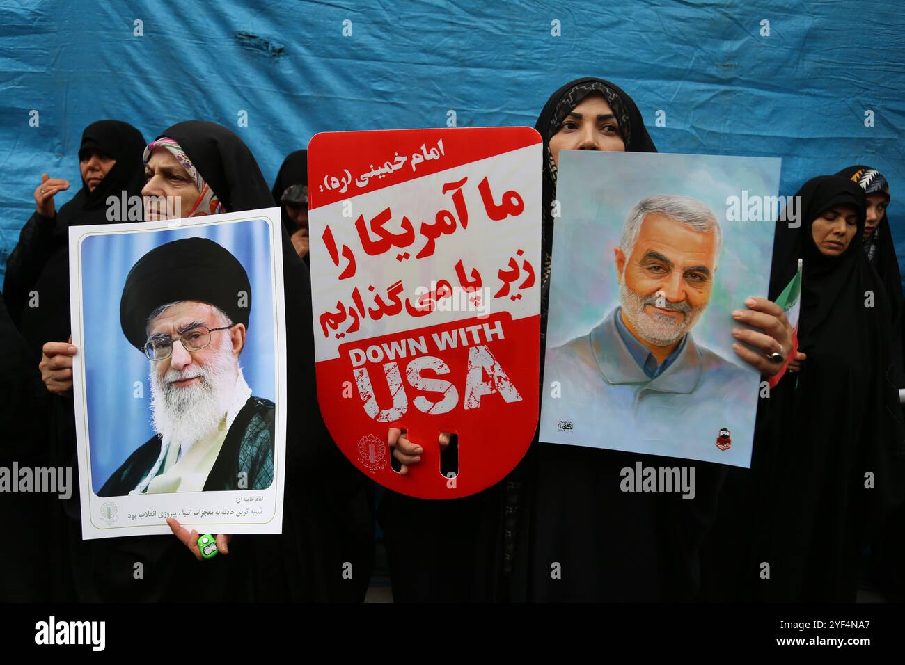 Tehran, Iran. 3rd Nov, 2024. Iranian veiled women hold a poster of ...