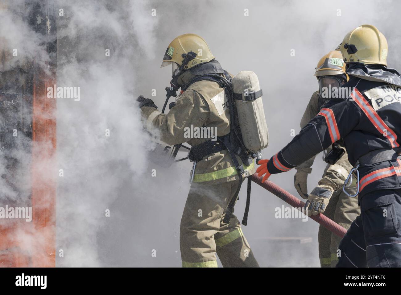 Firefighters extinguishes fire from fire hose, using fire-fighting ...