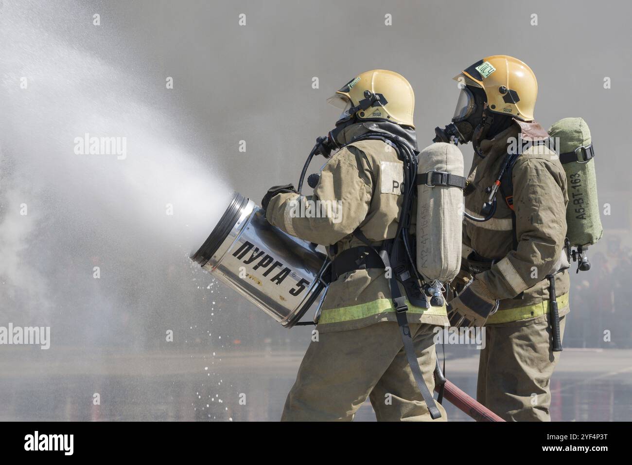 Firefighters extinguishes fire from fire hose, using fire-fighting ...
