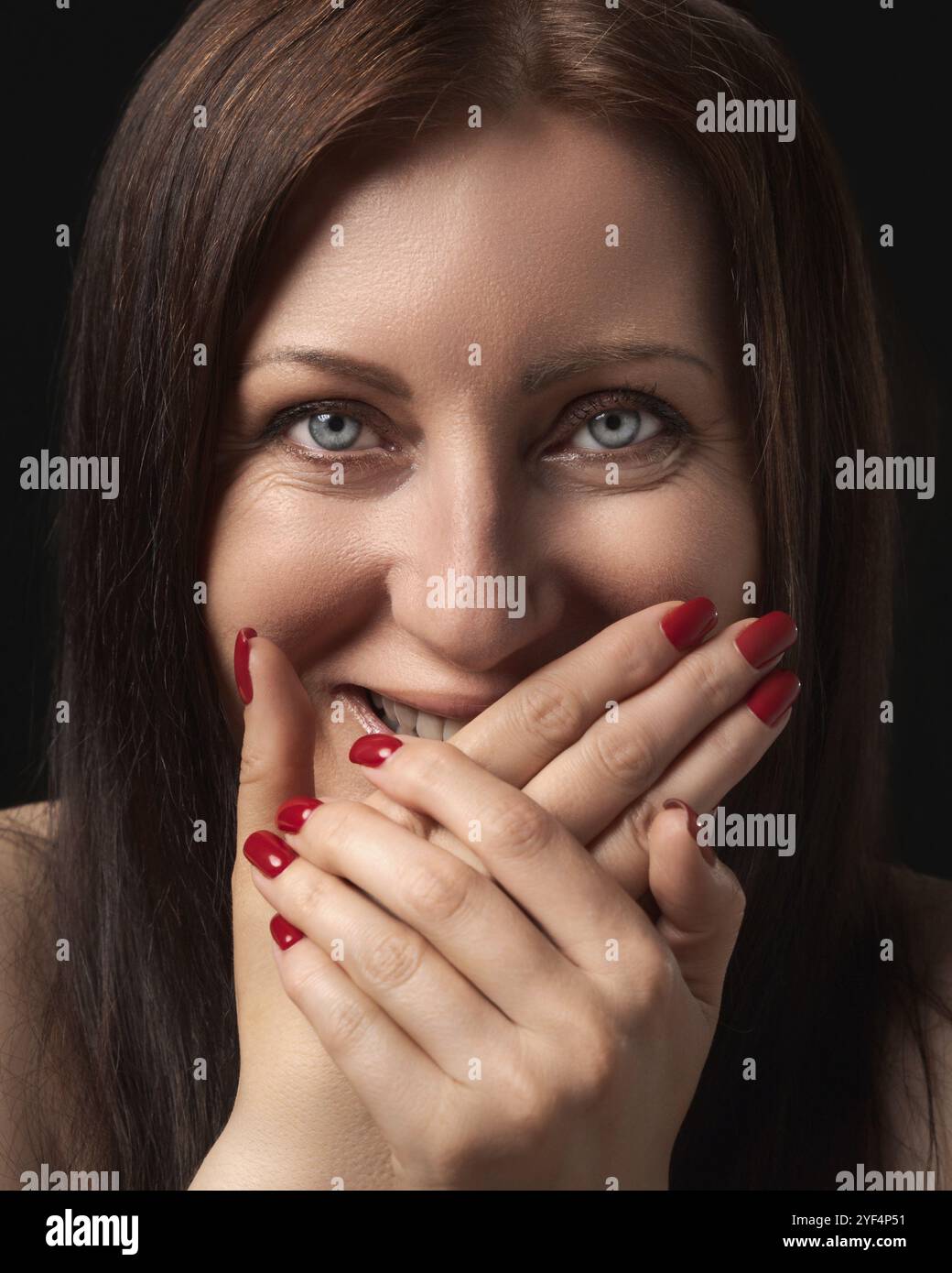 Happy woman covers hand laughing hi-res stock photography and images ...