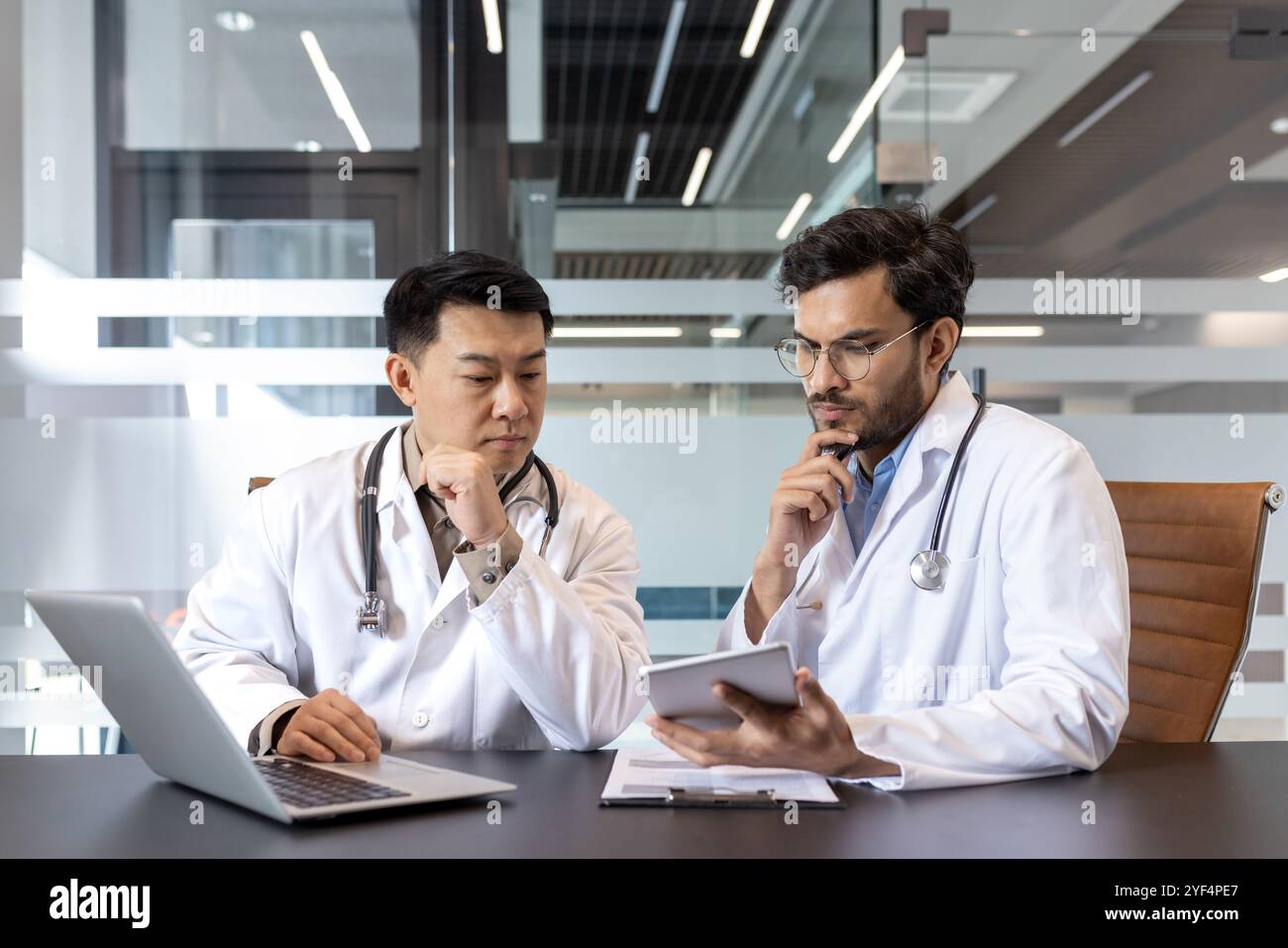 Two serious asian doctors team hi-res stock photography and images - Alamy